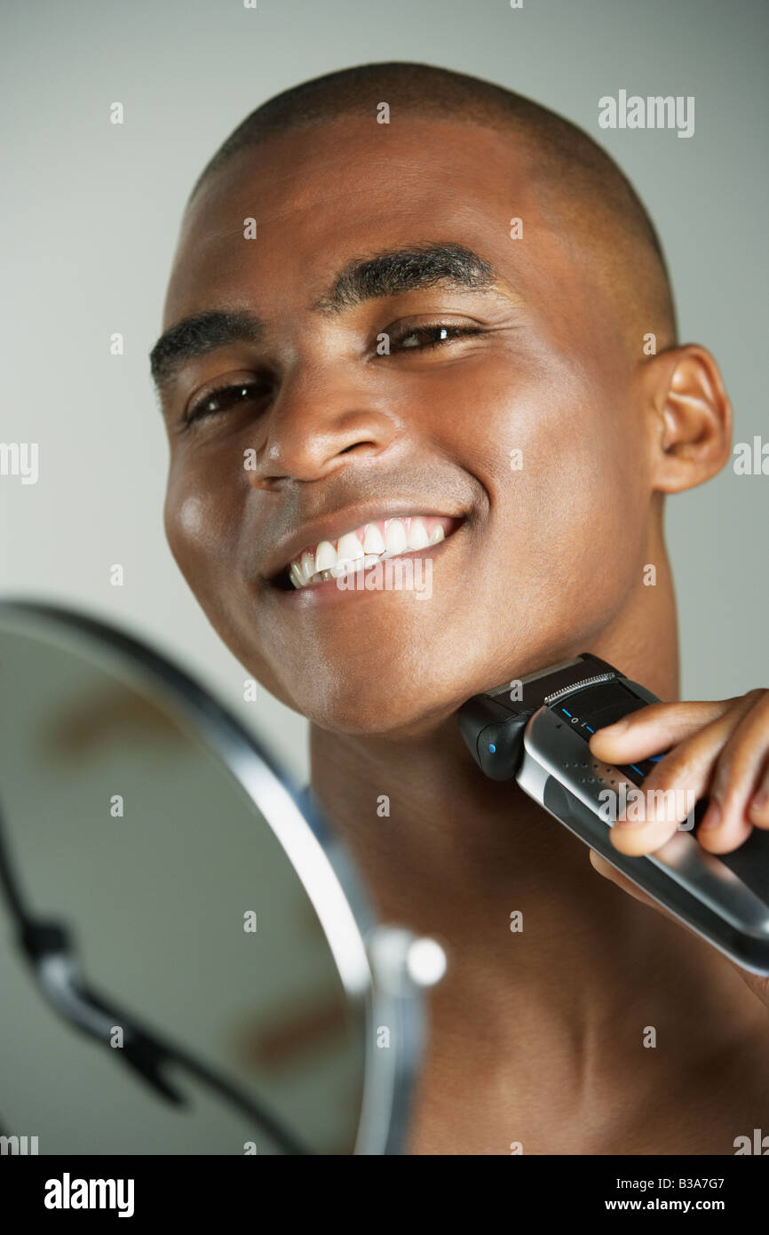 African man shaving with electric razor Stock Photo - Alamy
