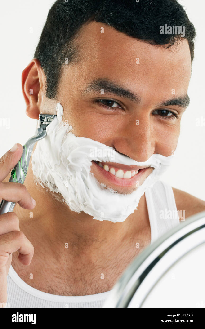 Hispanic man shaving face Stock Photo - Alamy