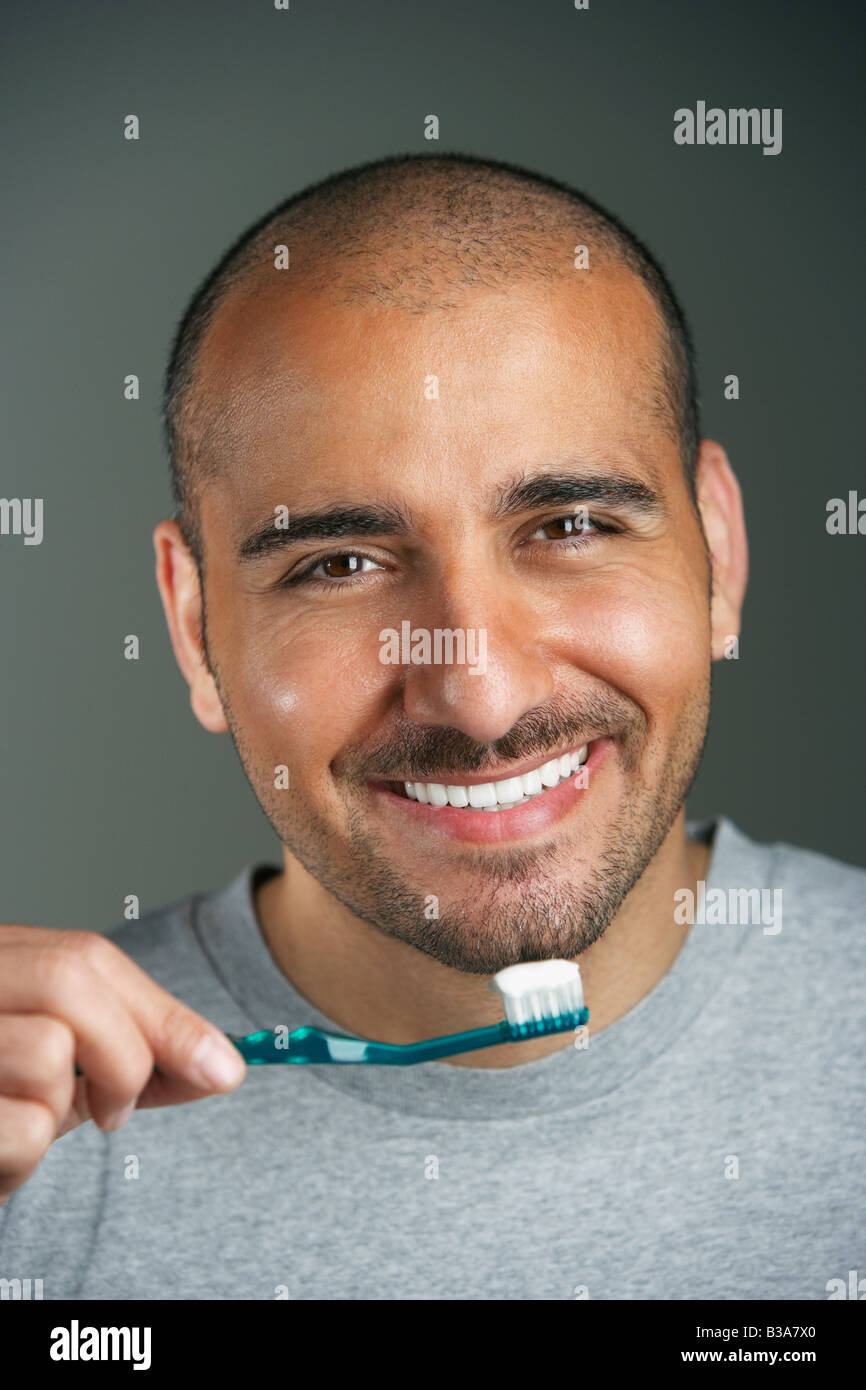 Middle Eastern man brushing teeth Stock Photo - Alamy