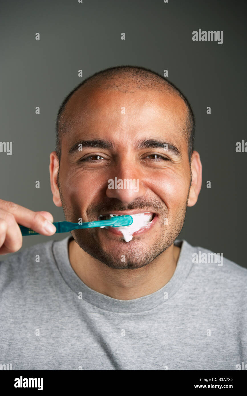Middle Eastern man brushing teeth Stock Photo - Alamy