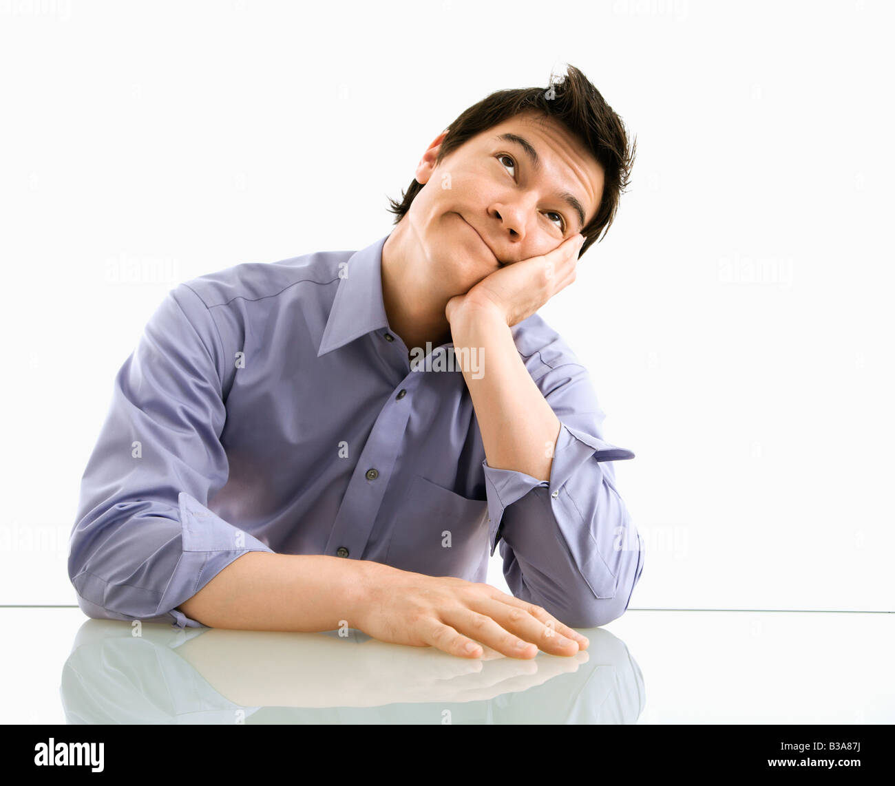 Young Asian business man sitting daydreaming Stock Photo - Alamy