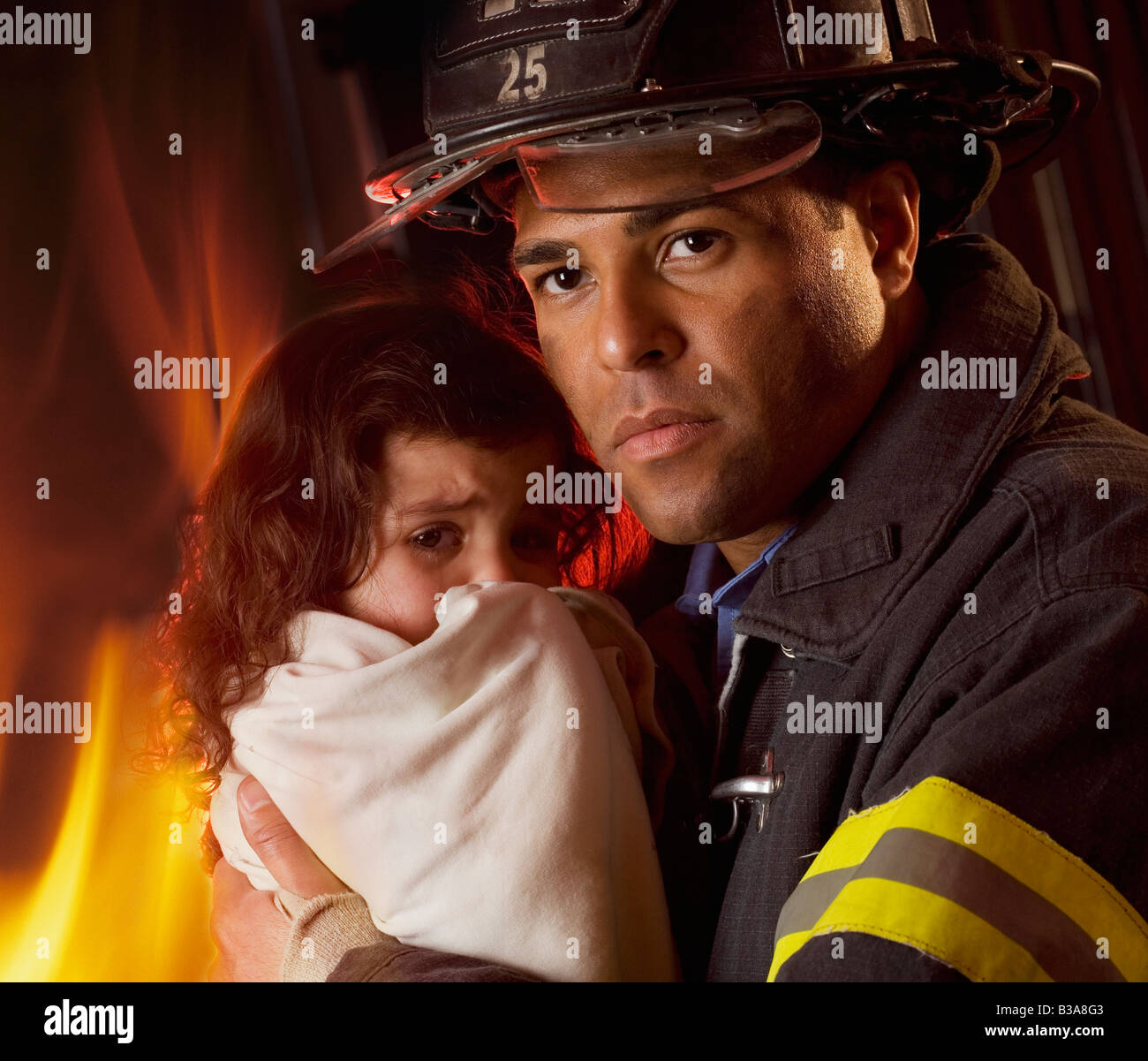 Hispanic male firefighter holding child Stock Photo - Alamy