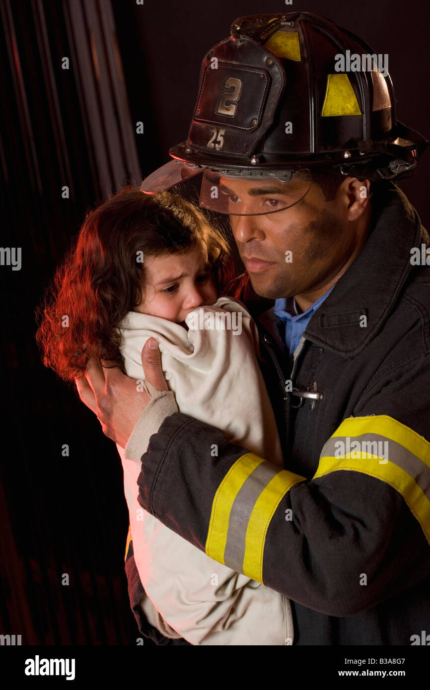Hispanic male firefighter holding child hi-res stock photography and ...