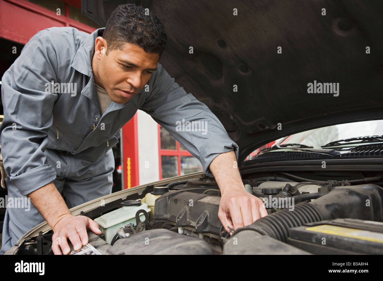 Male Mechanic Under Car