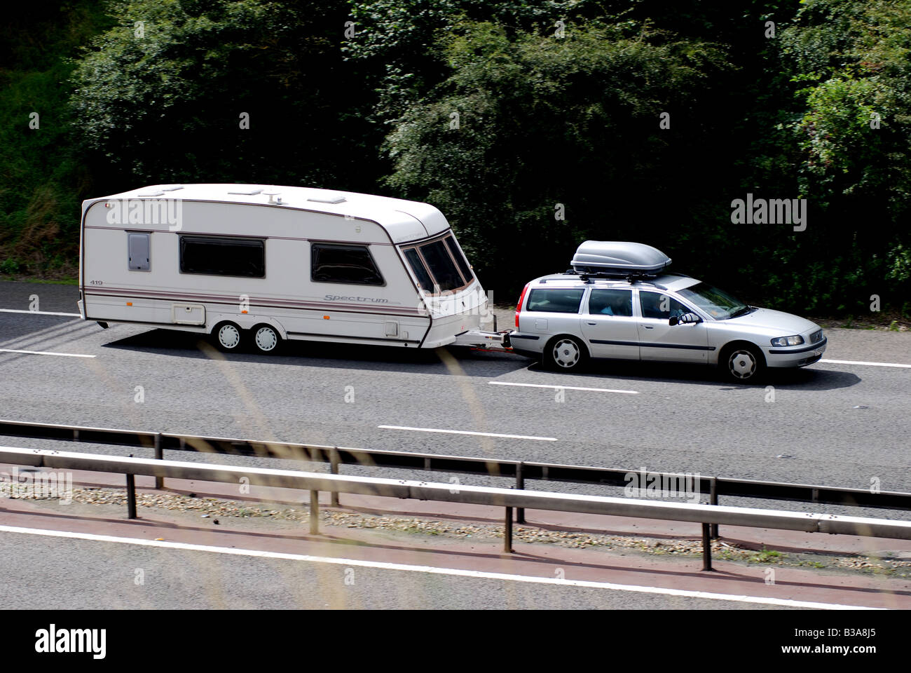 Volvo estate car towing caravan on M40 motorway England UK Stock Photo ...