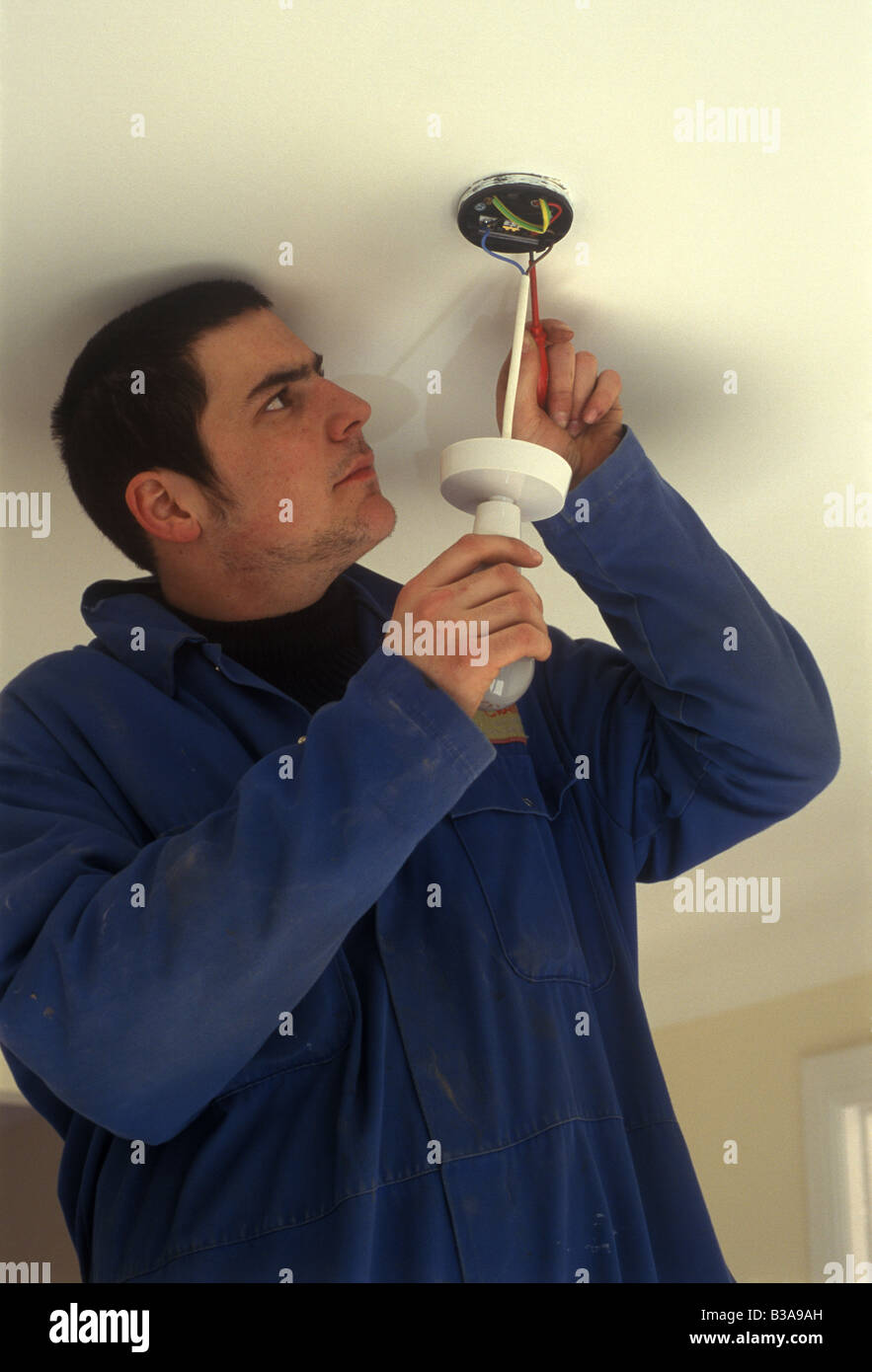 electrician wiring a ceiling rose in a new house Stock Photo - Alamy
