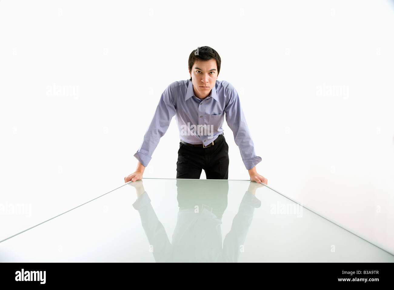 Young Asian business man standing over conference table Stock Photo - Alamy