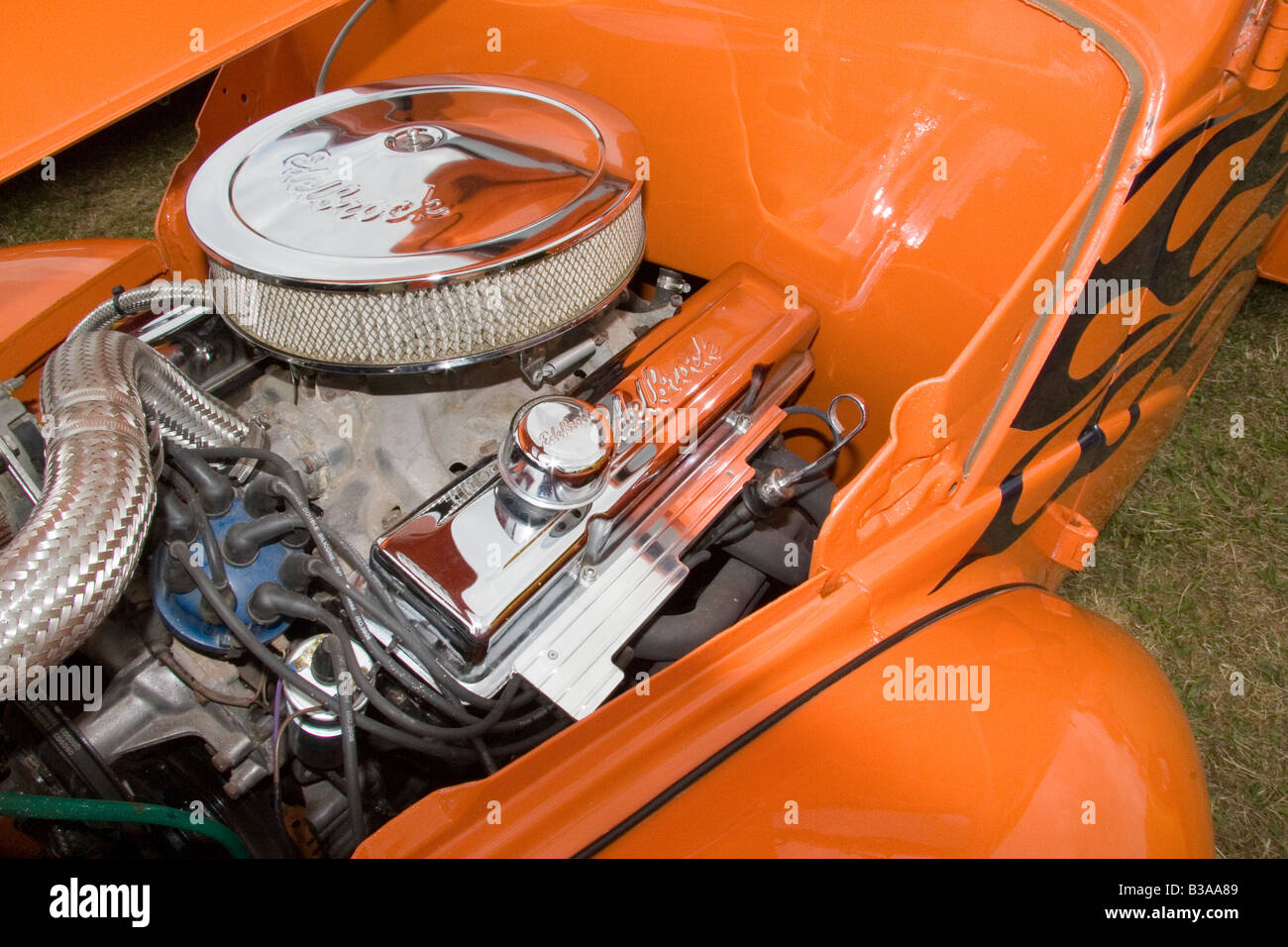 Heavily chromed V8 engine in an orange hot rod built on a Ford Popular ...
