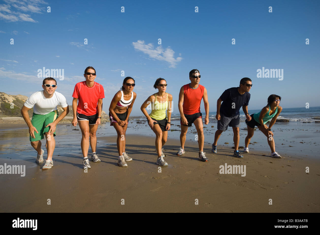 Multi-ethnic runners racing at beach Stock Photo - Alamy