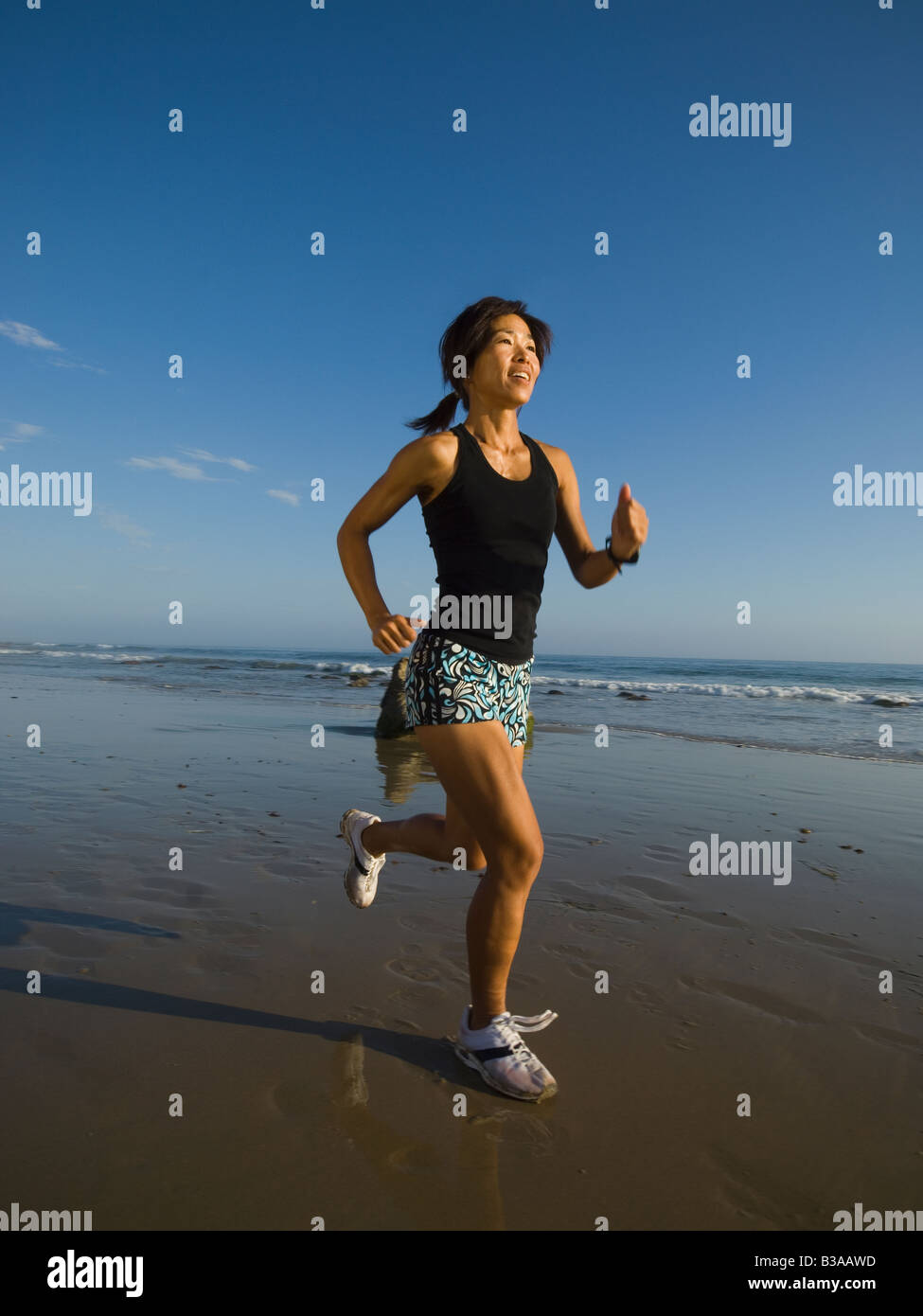 Asian woman running at beach Stock Photo - Alamy
