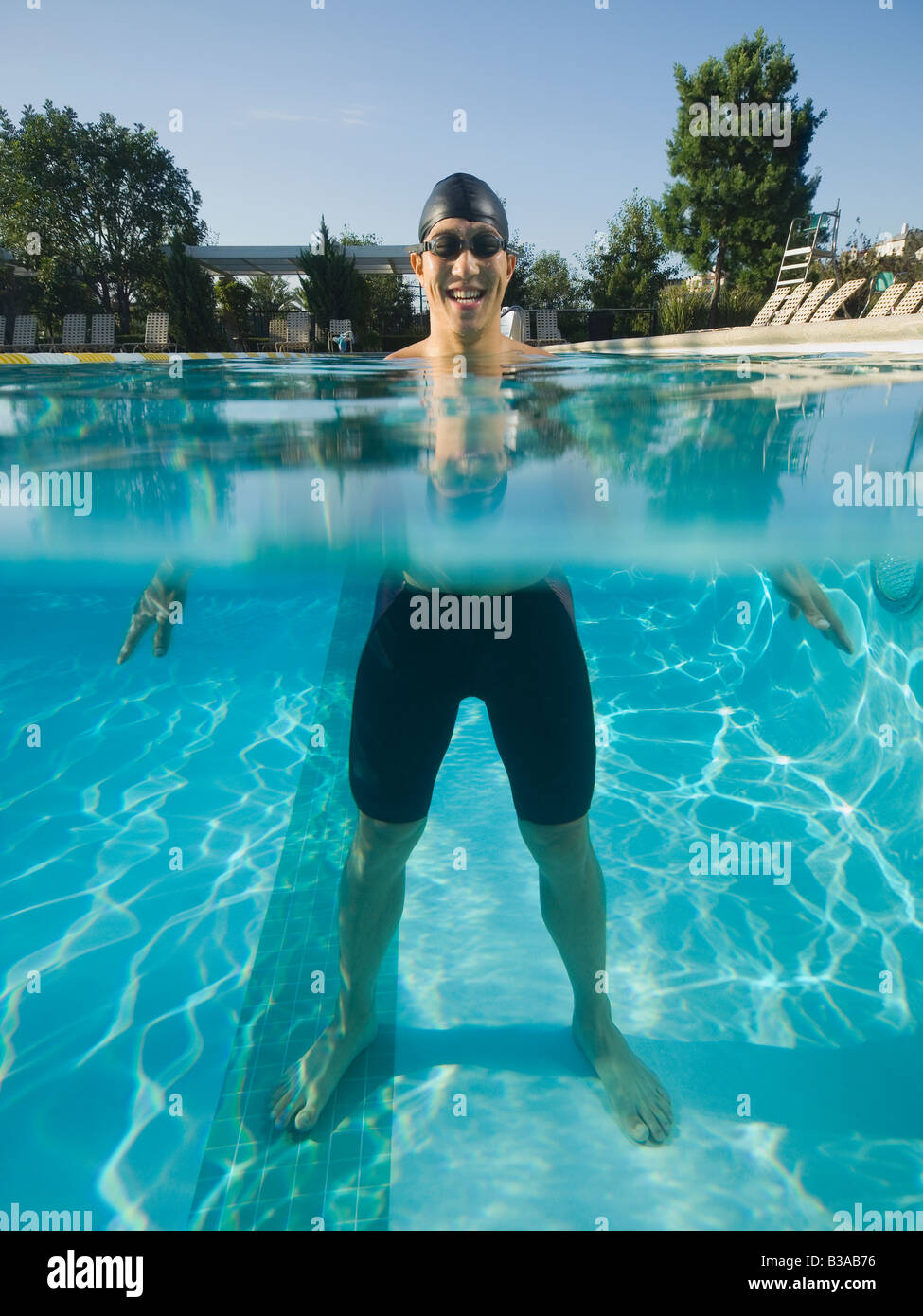 Asian man standing in swimming pool Stock Photo - Alamy