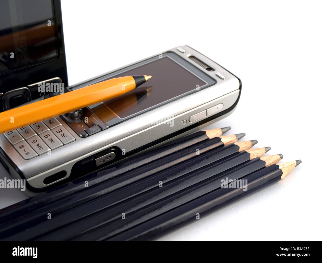 Modern Mobile Phones Pens and Pencils on White Background Stock Photo ...