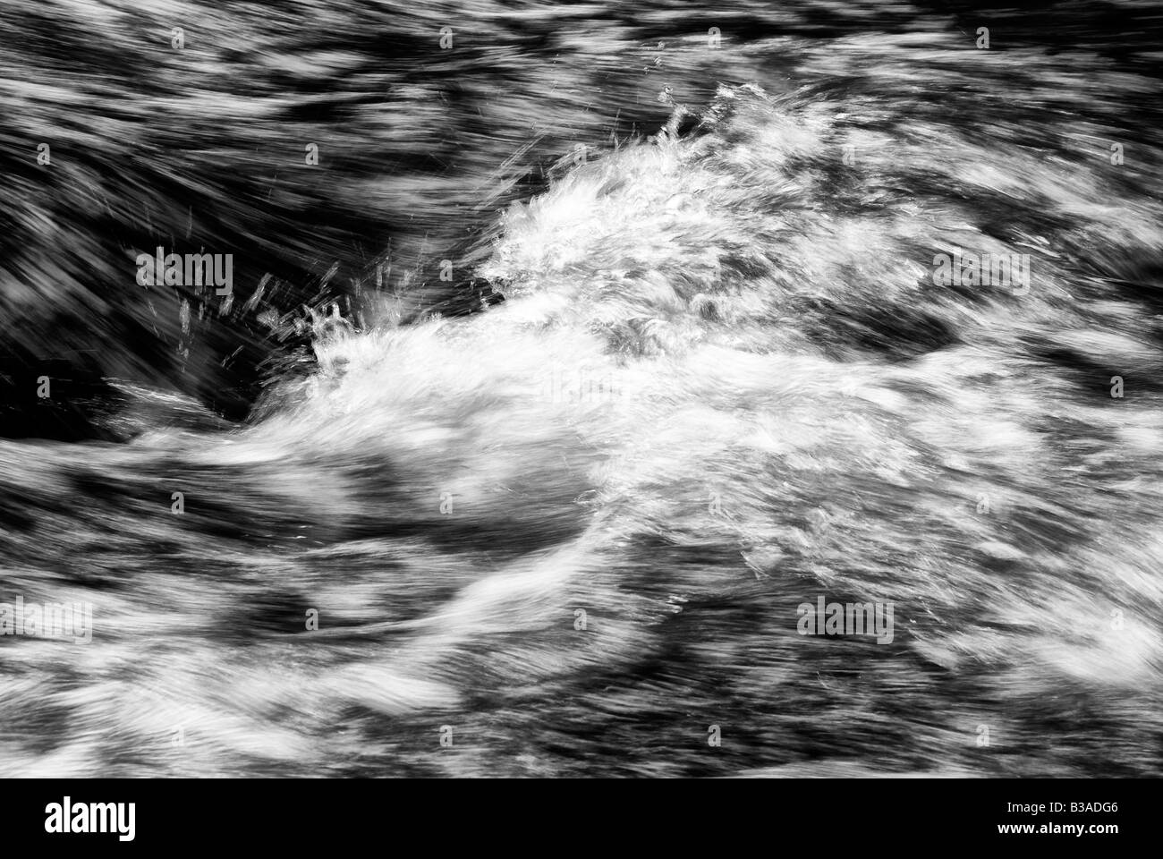 Monochromatic close-up view of fast moving water and white spray at ...