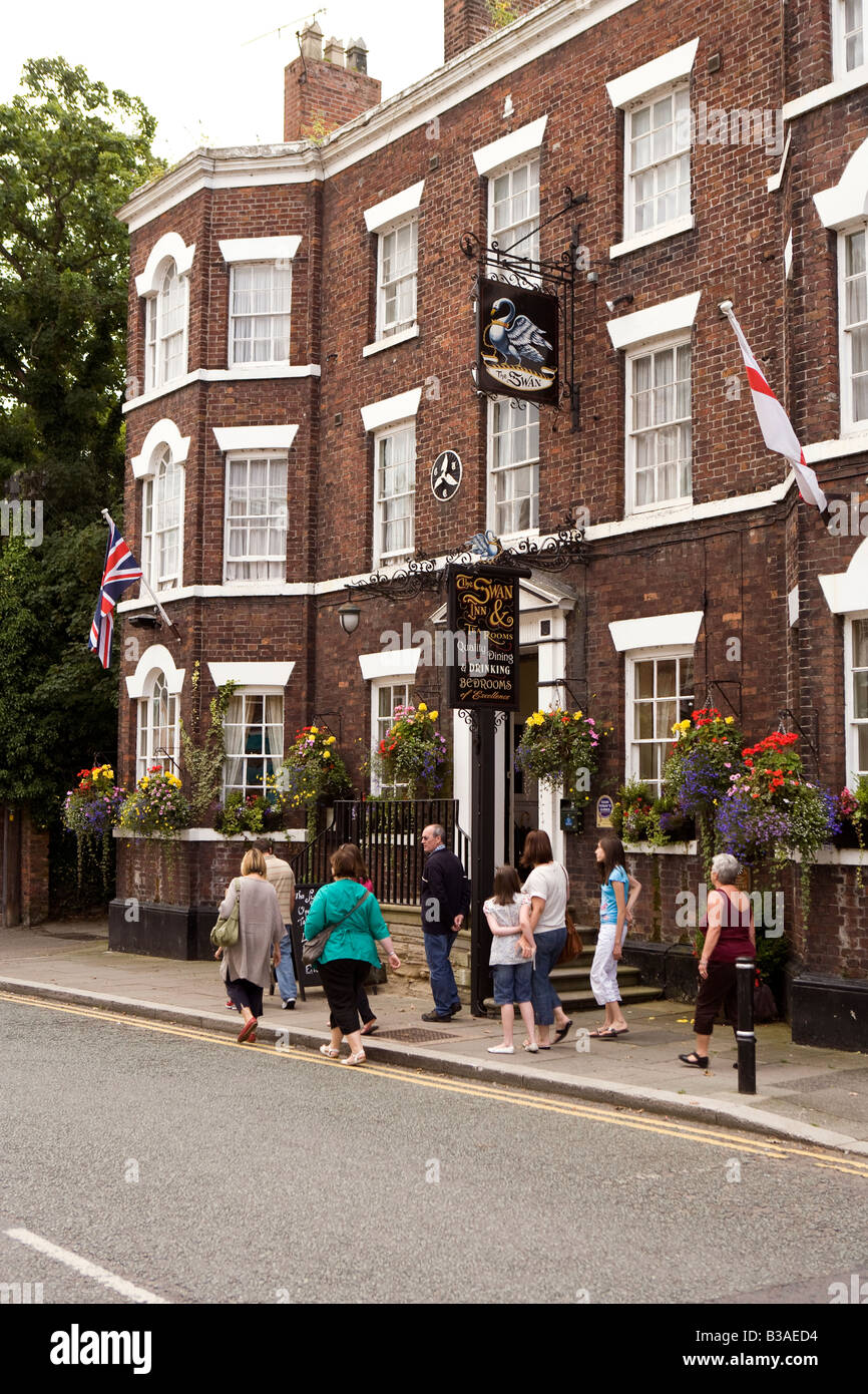 UK Cheshire Tarporley village Centre High Street visitors walking past ...