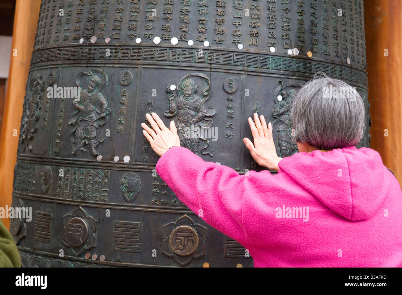 Woman placing hands on buddhist image Stock Photo - Alamy