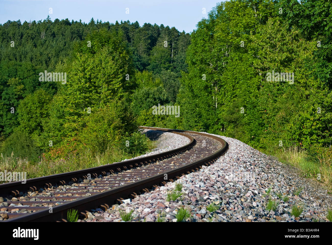 Railroad track disappearing around a curve Stock Photo - Alamy