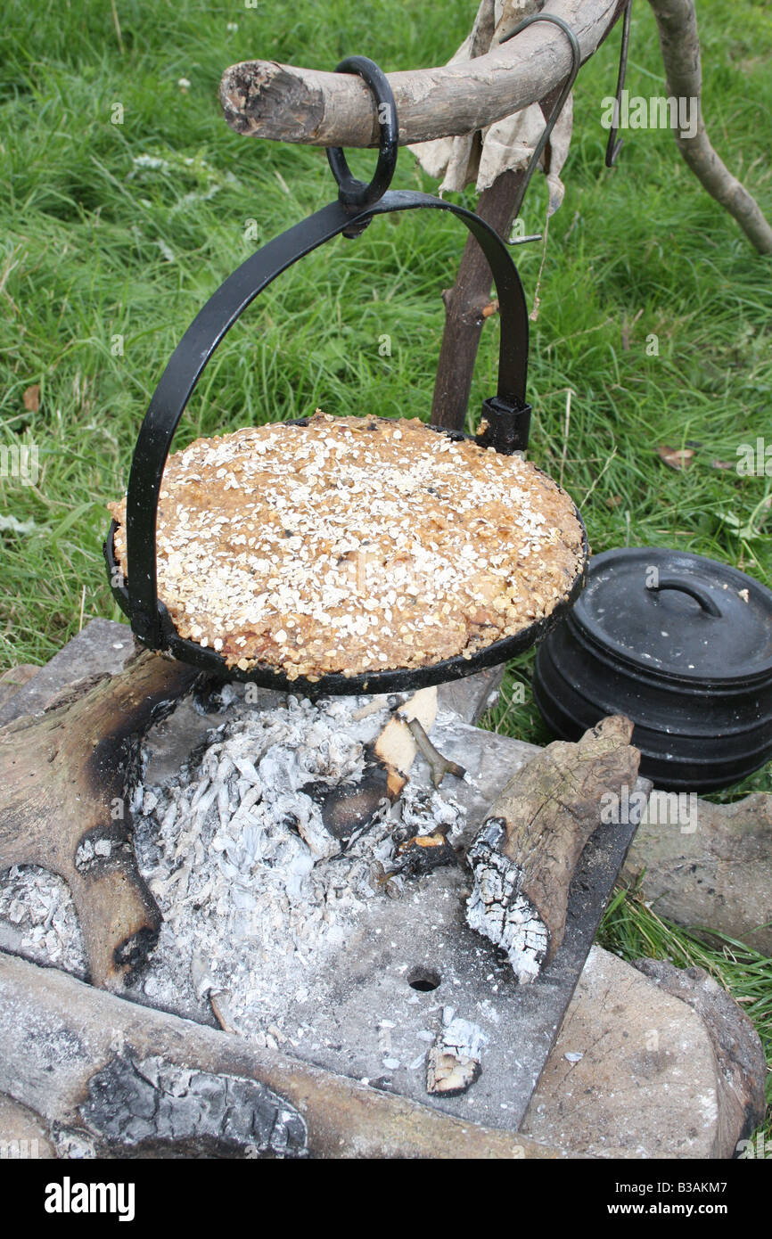 17th century bread being made on an open fire during the re-enactment ...