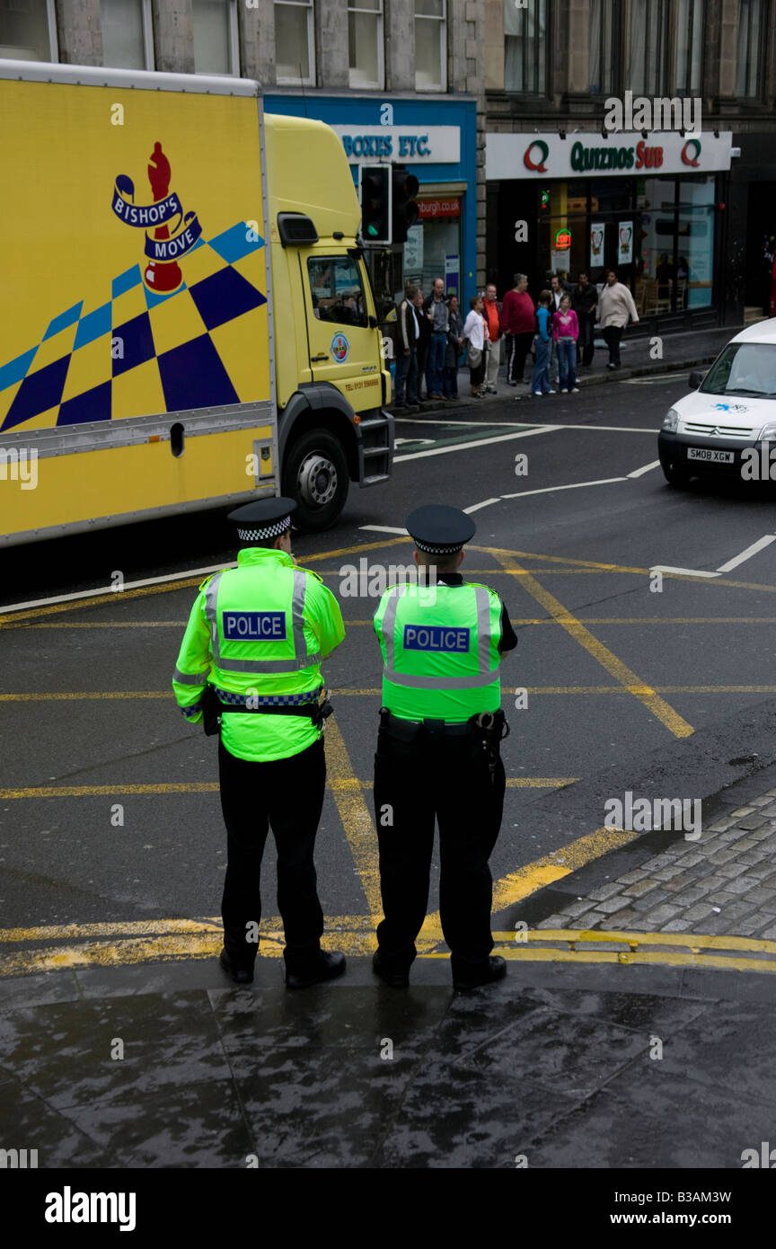 Two male Police officer stand at kerb busy road, South Bridge ...