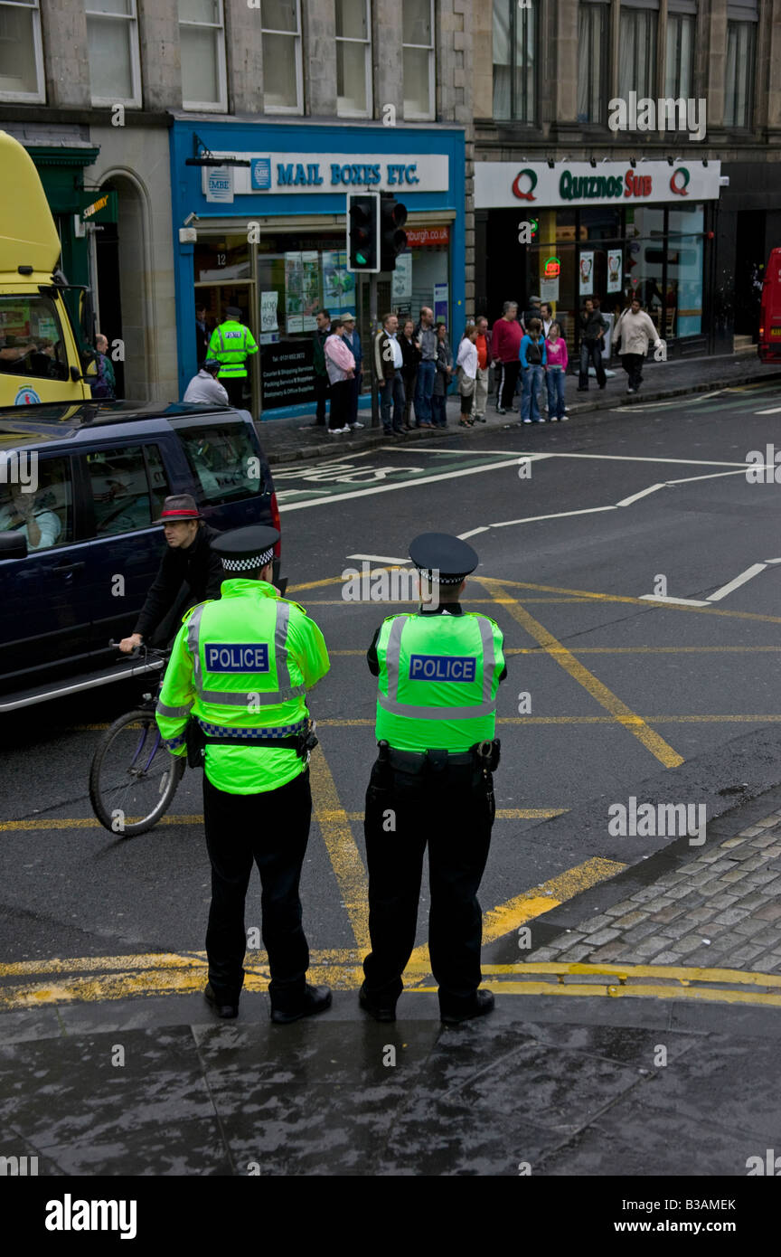 Two male Police officers stand at kerb on main road, Edinburgh ...