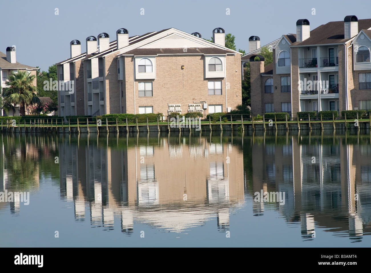 Apartment building reflection in lake water Stock Photo - Alamy