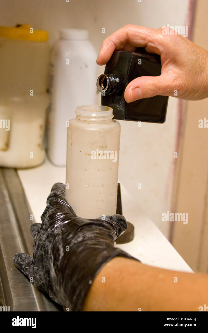 A hairdresser mixing a hair color formula in the back room Stock Photo ...