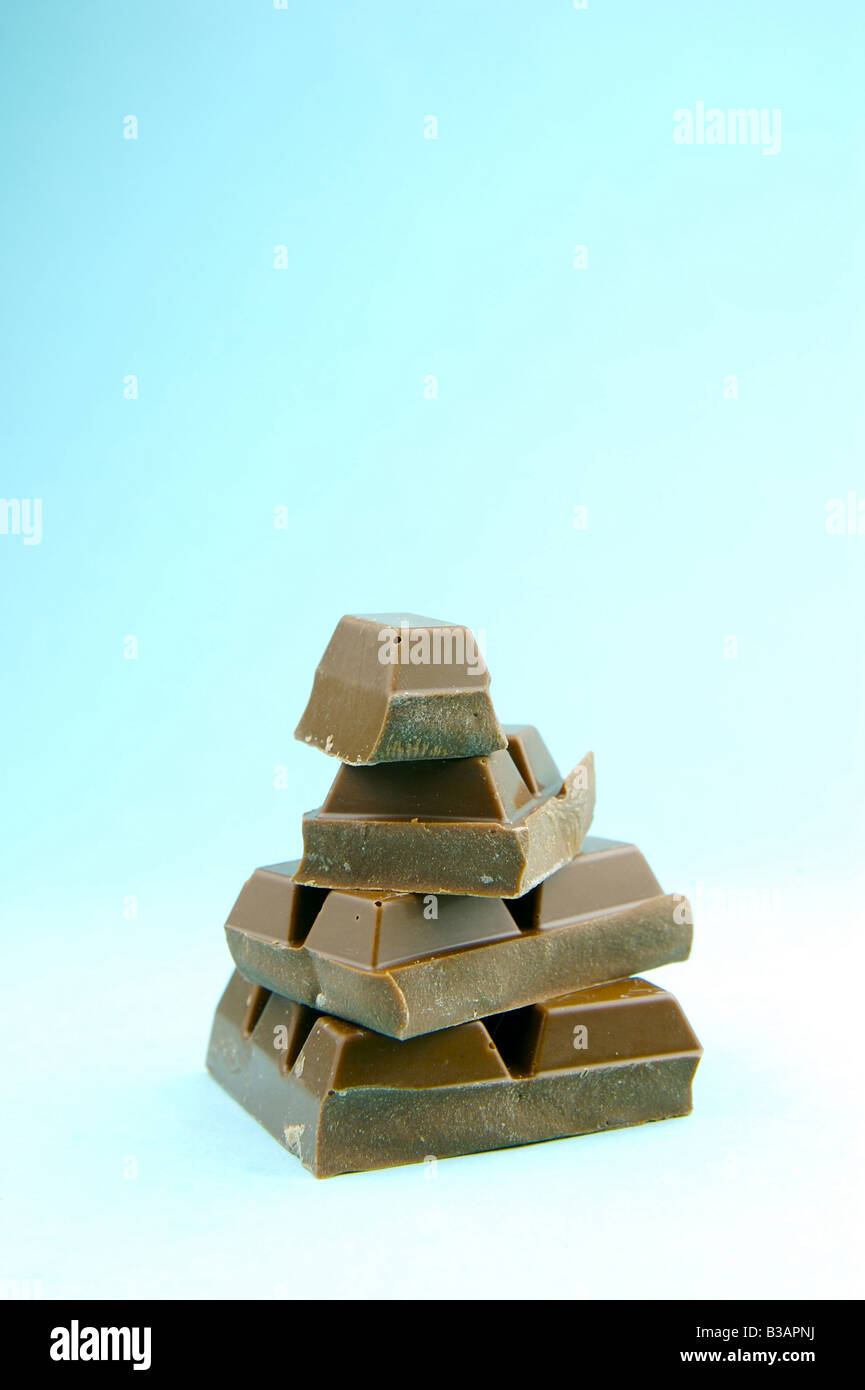 Chocolate isolated against a blue background Stock Photo - Alamy