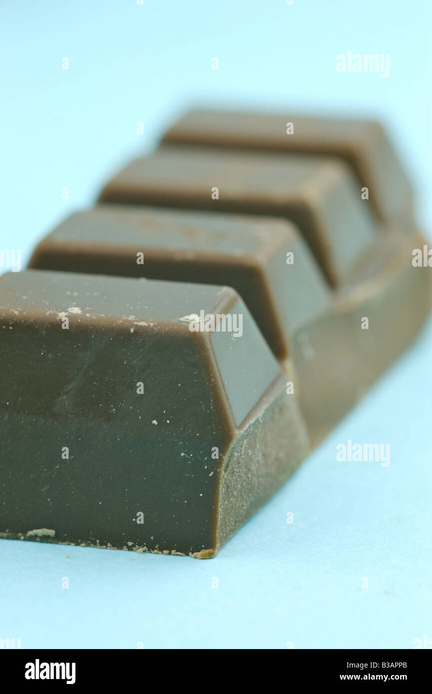 Chocolate isolated against a blue background Stock Photo - Alamy