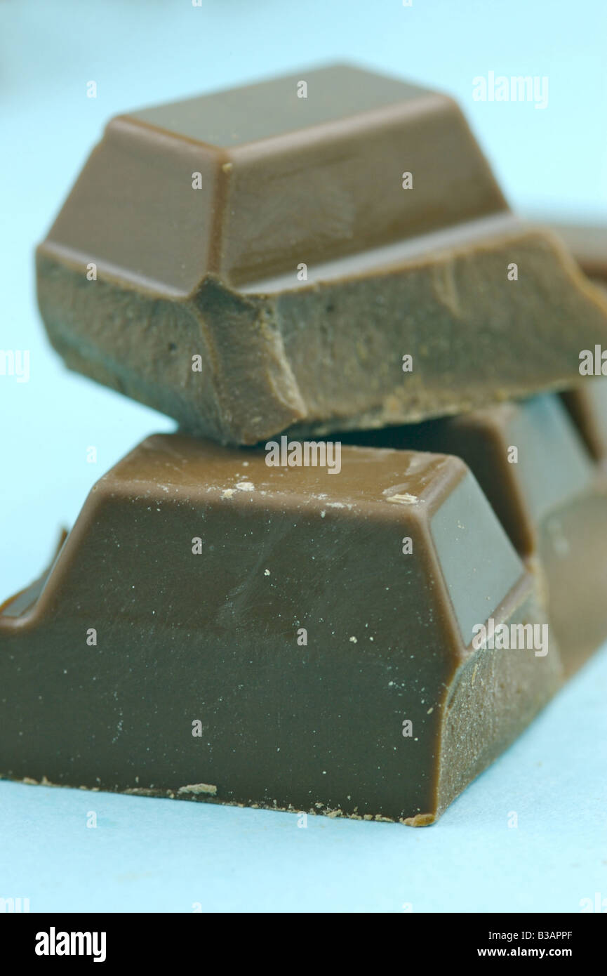 Chocolate isolated against a blue background Stock Photo - Alamy