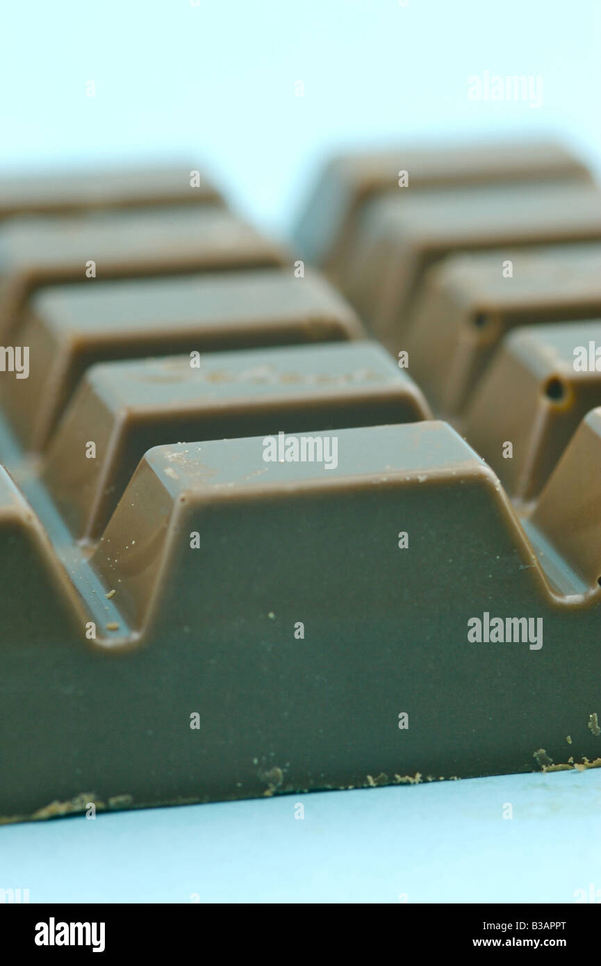 Chocolate isolated against a blue background Stock Photo - Alamy