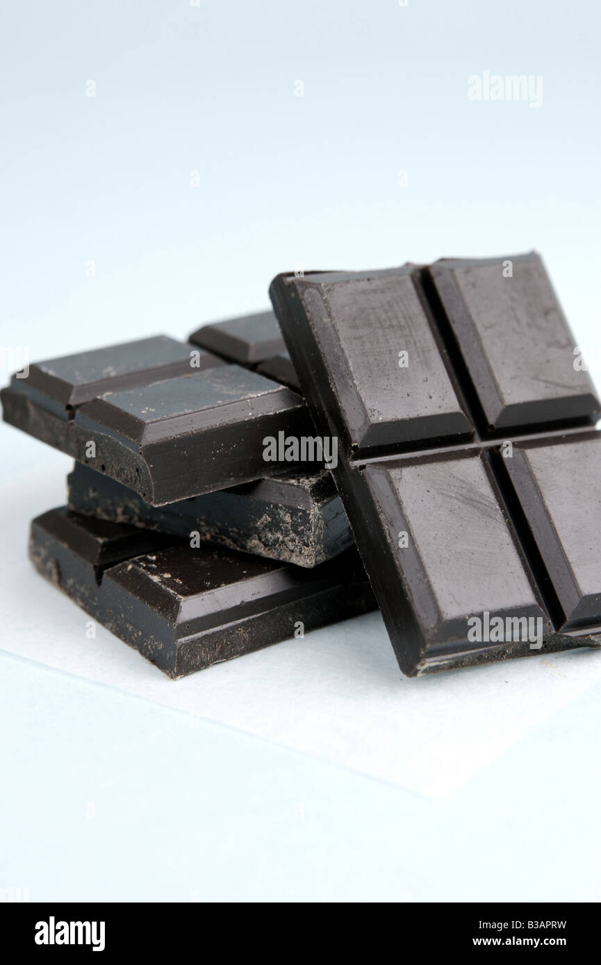 Dark Chocolate isolated against a blue background Stock Photo - Alamy