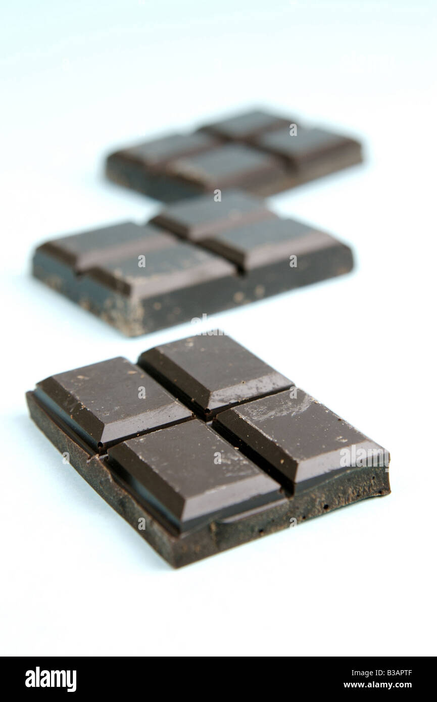 Dark Chocolate isolated against a blue background Stock Photo - Alamy