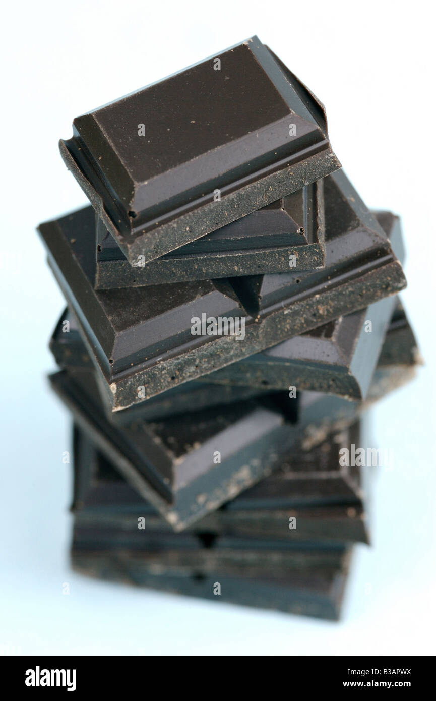 Dark Chocolate isolated against a blue background Stock Photo - Alamy