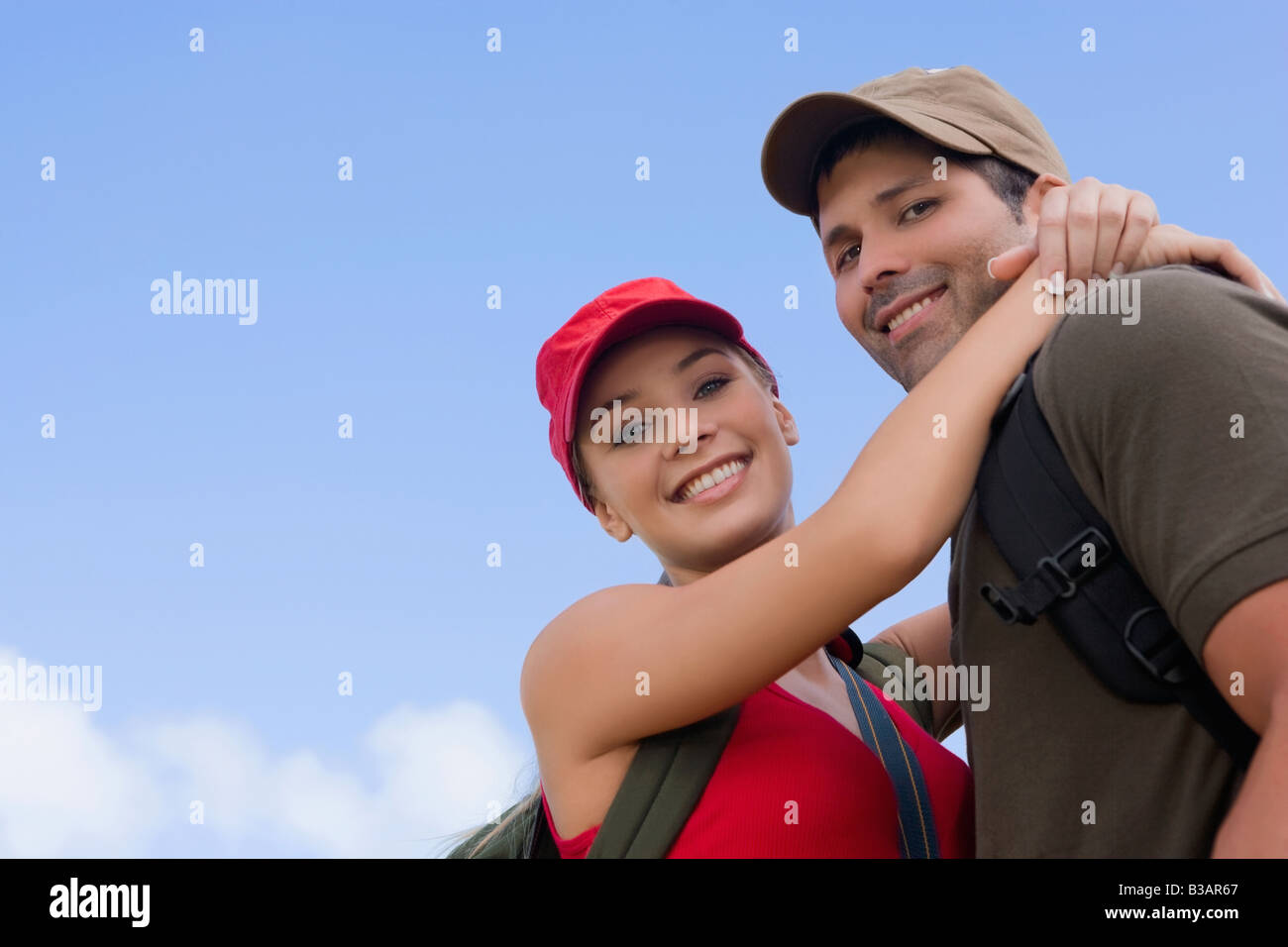 Hispanic couple hugging Stock Photo - Alamy