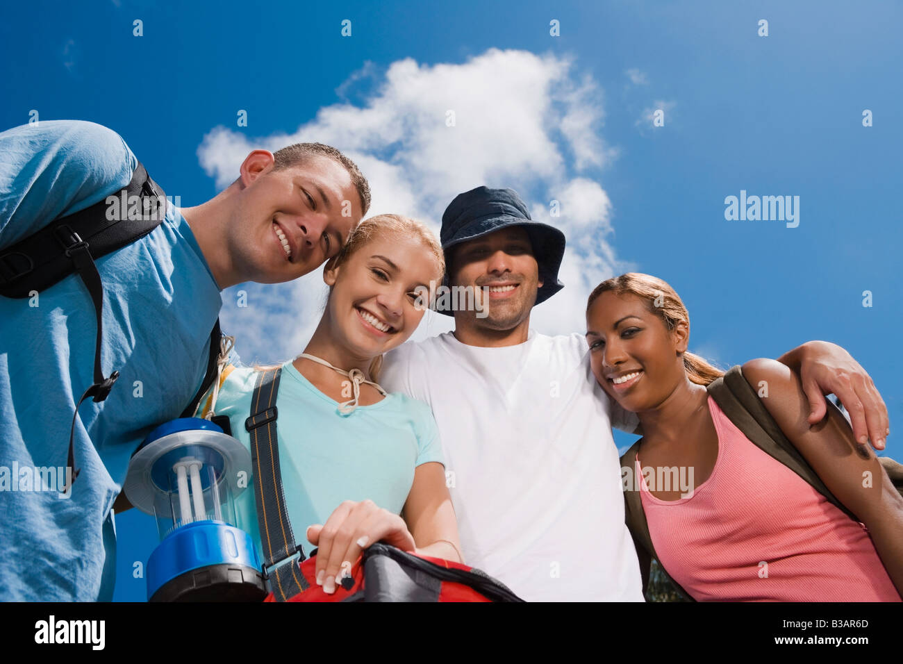 Multi-ethnic friends hugging Stock Photo - Alamy