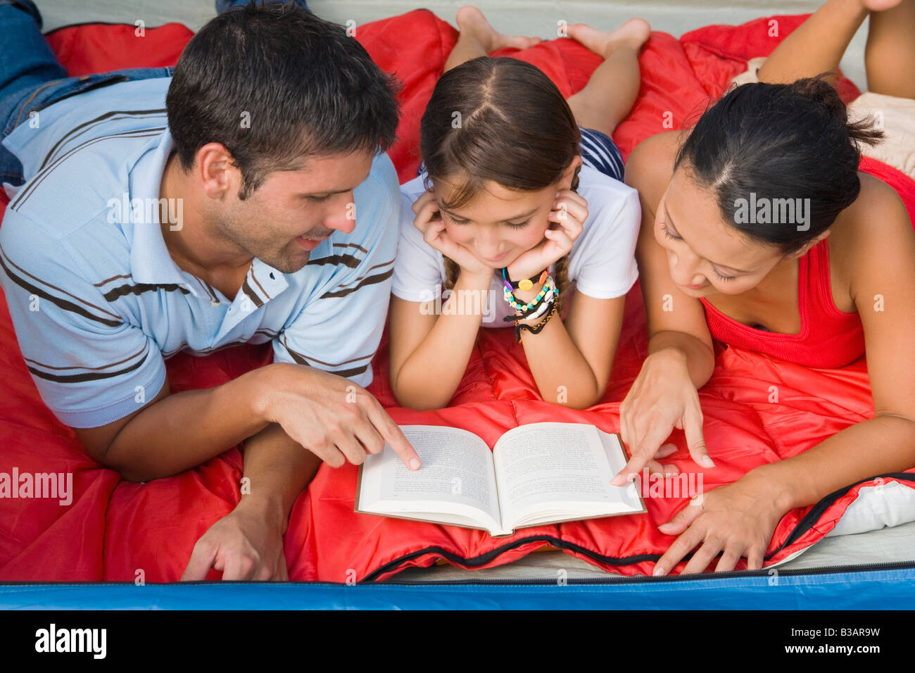 Hispanic family reading Stock Photo - Alamy