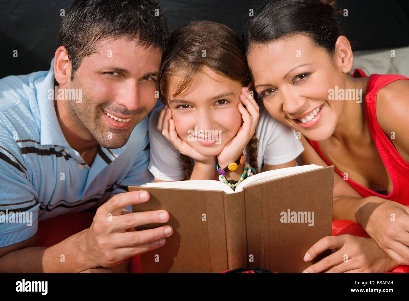 Hispanic family reading Stock Photo - Alamy