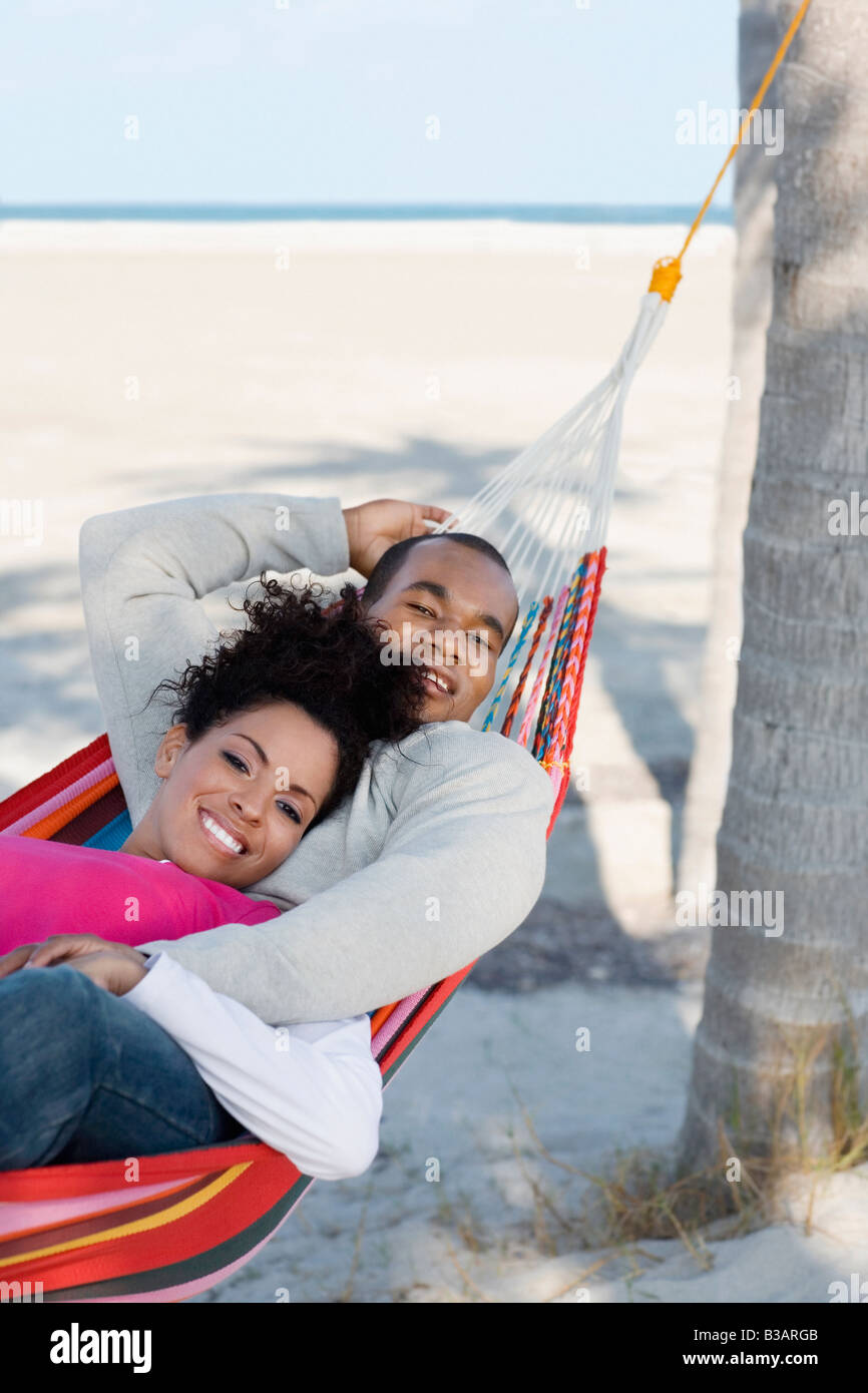 Hispanic couple laying in hammock Stock Photo - Alamy