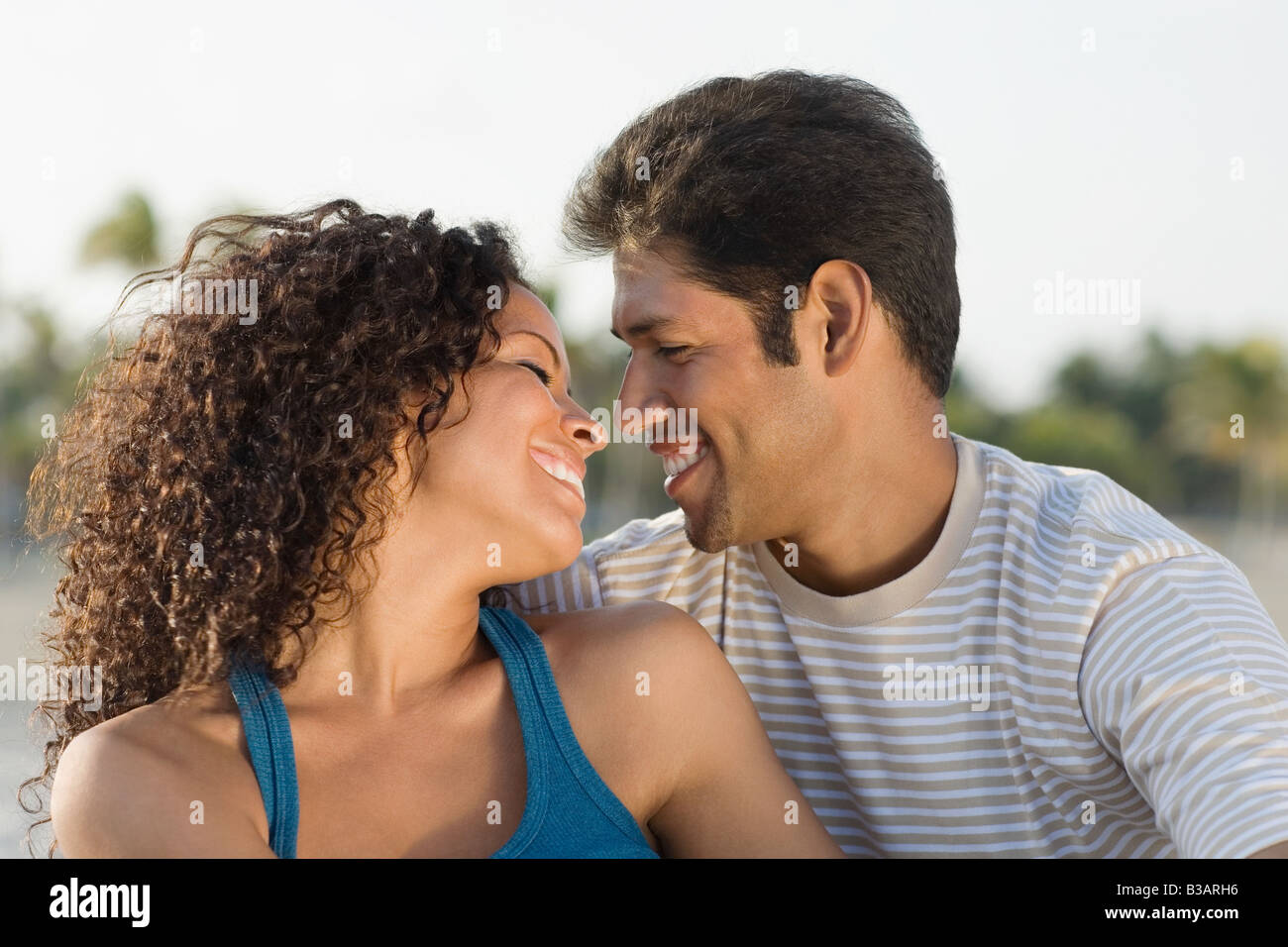 Hispanic couple smiling at each other Stock Photo - Alamy