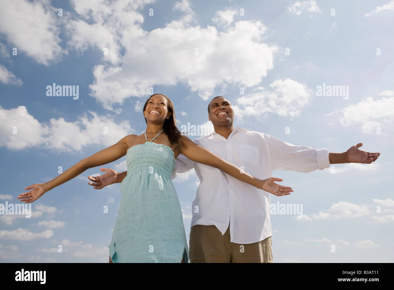 African couple with arms outstretched Stock Photo - Alamy