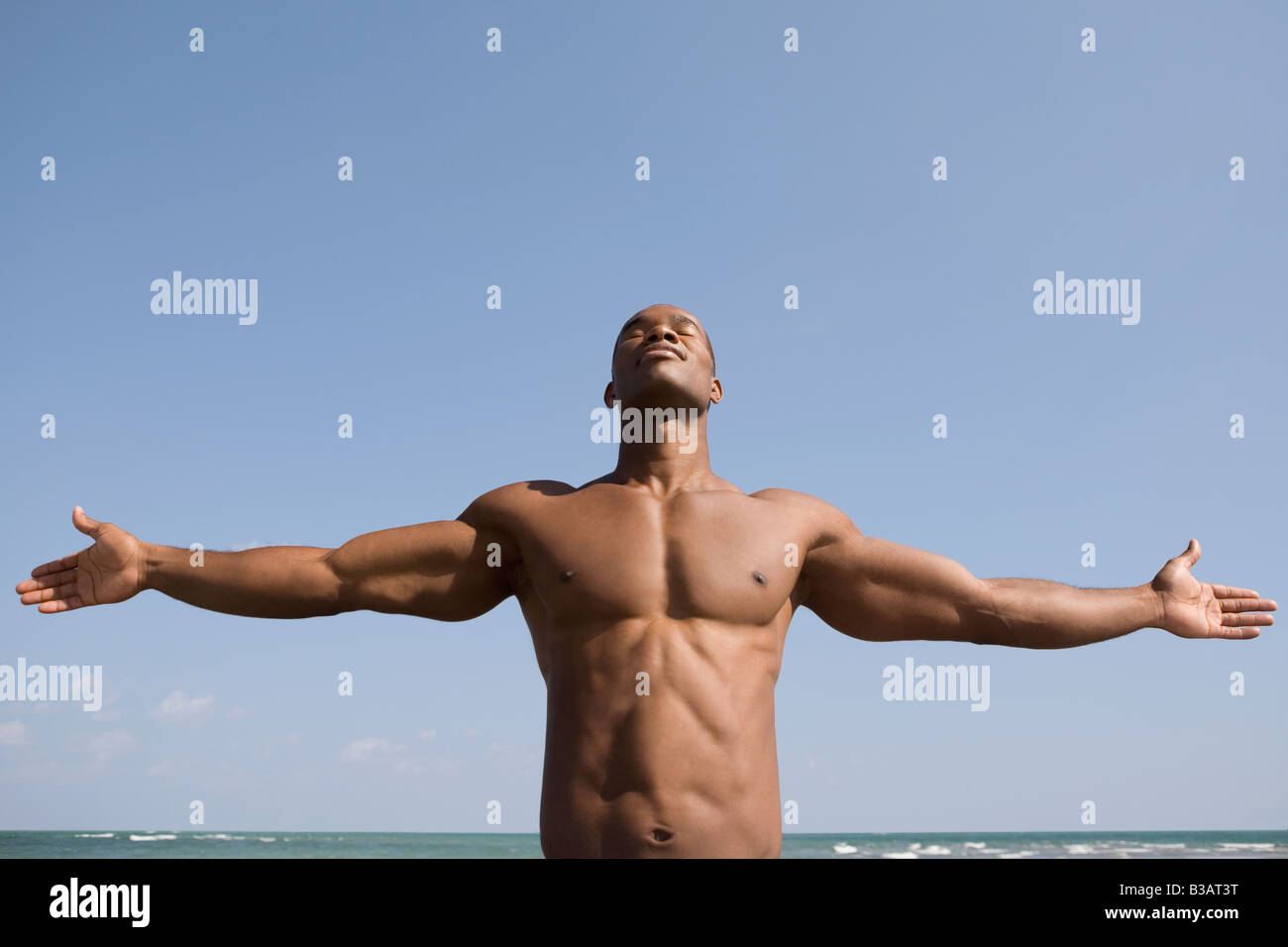 Bare-chested man with arms outstretched Stock Photo - Alamy