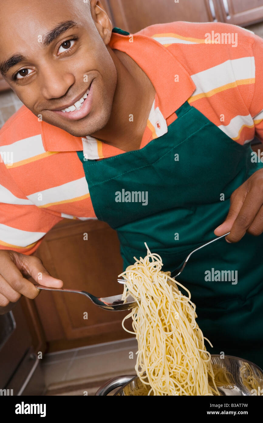 African man serving spaghetti Stock Photo - Alamy