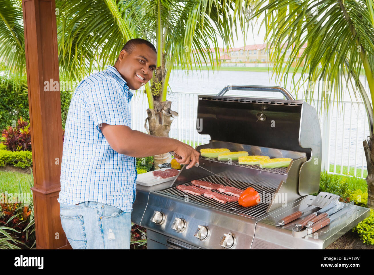 African man barbecuing Stock Photo - Alamy