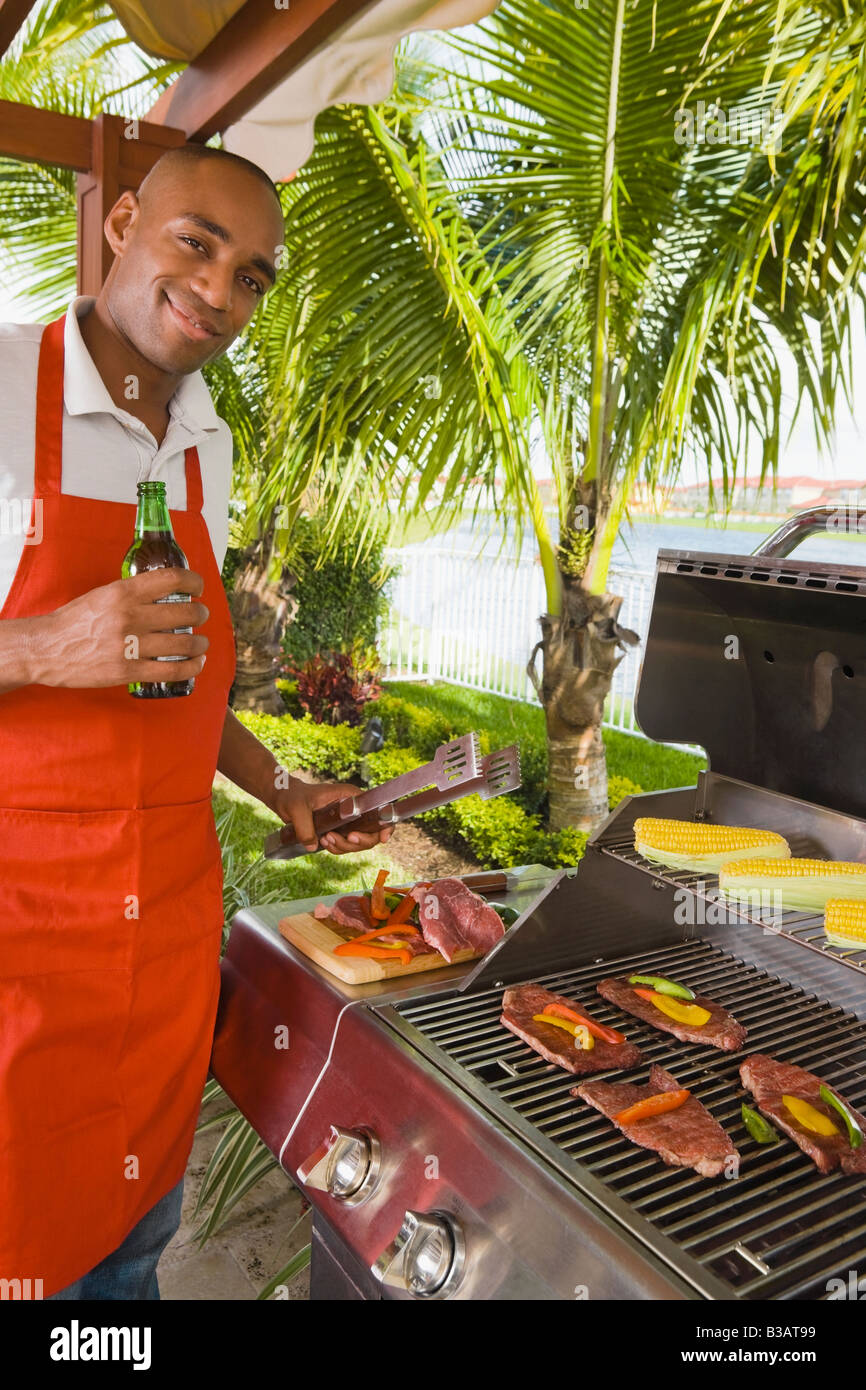 African man barbecuing Stock Photo - Alamy