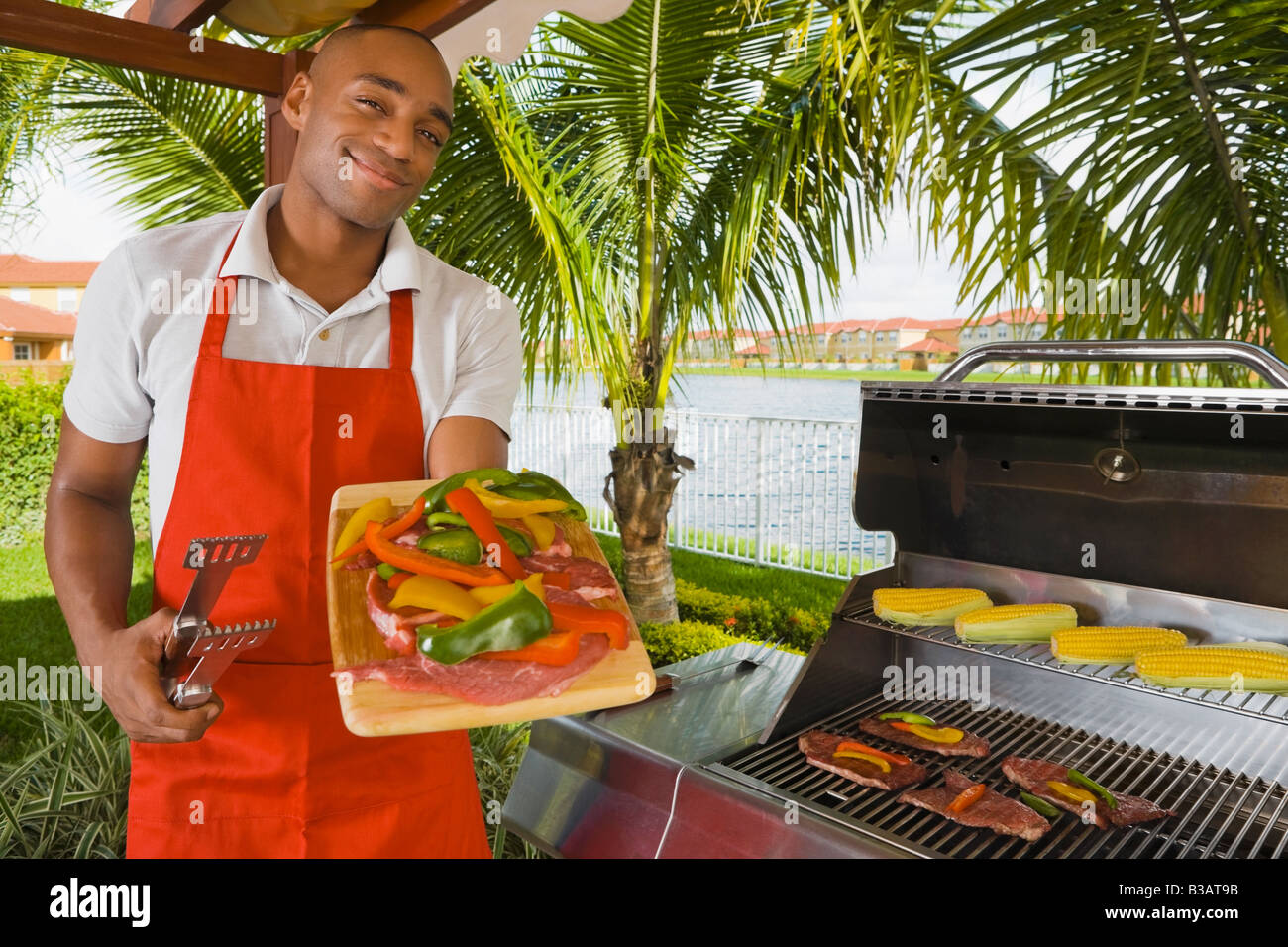 African man barbecuing Stock Photo - Alamy