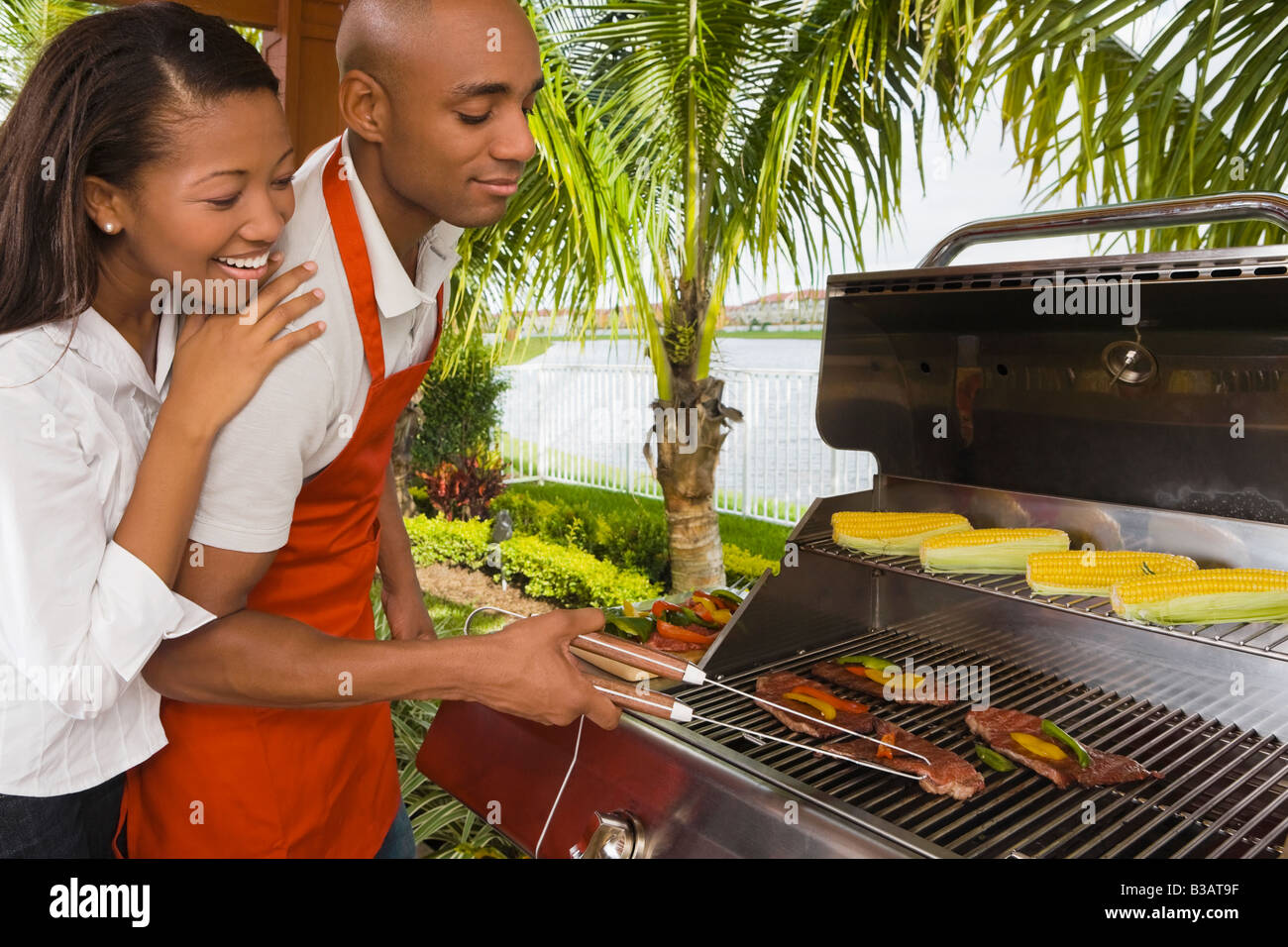 African couple barbecuing Stock Photo - Alamy