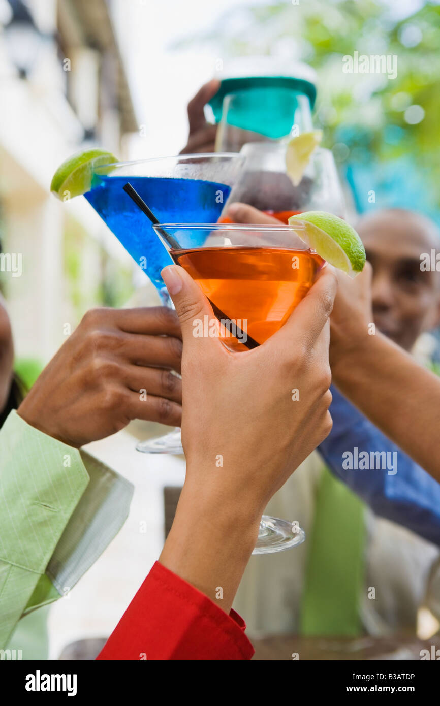 Hispanic friends toasting with cocktails Stock Photo - Alamy