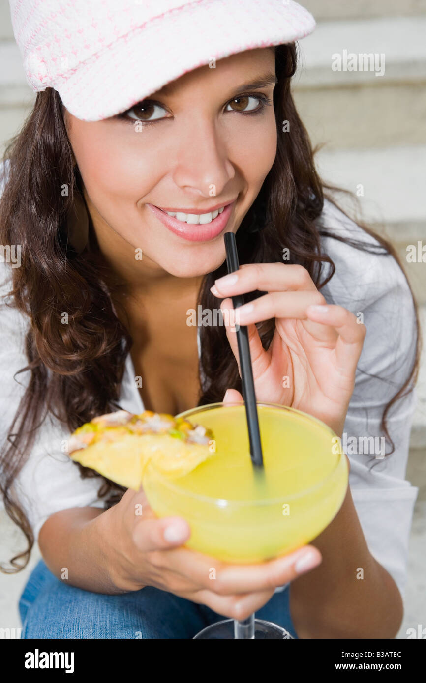 Hispanic woman drinking cocktail Stock Photo - Alamy