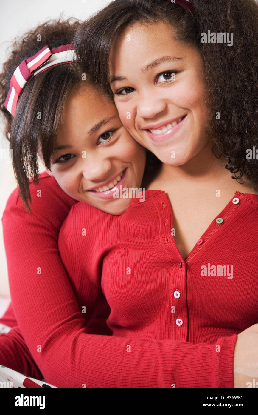 African twin sisters hugging Stock Photo - Alamy