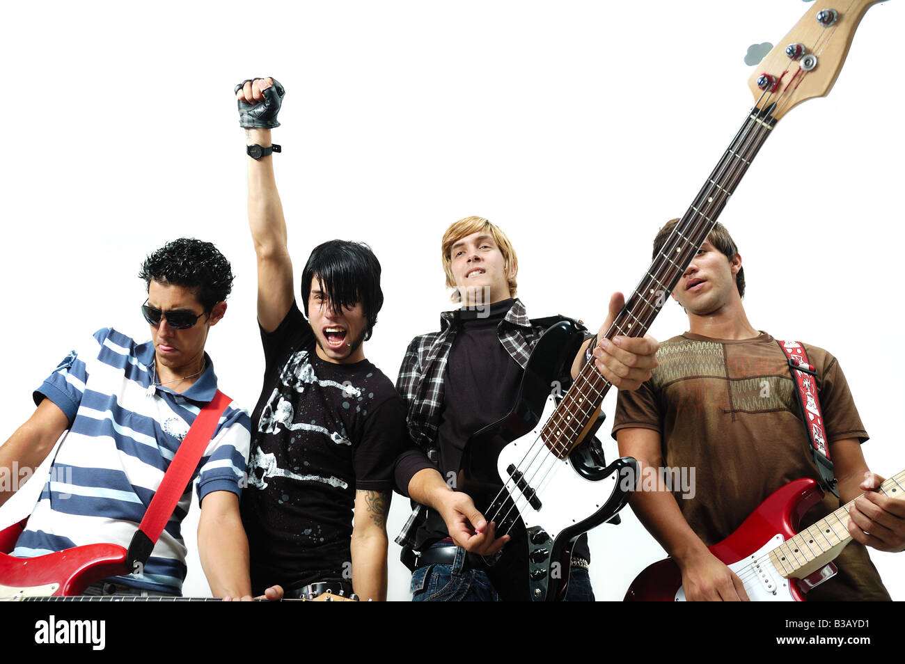 Portrait of young trendy musicians posing with instruments - isolated ...