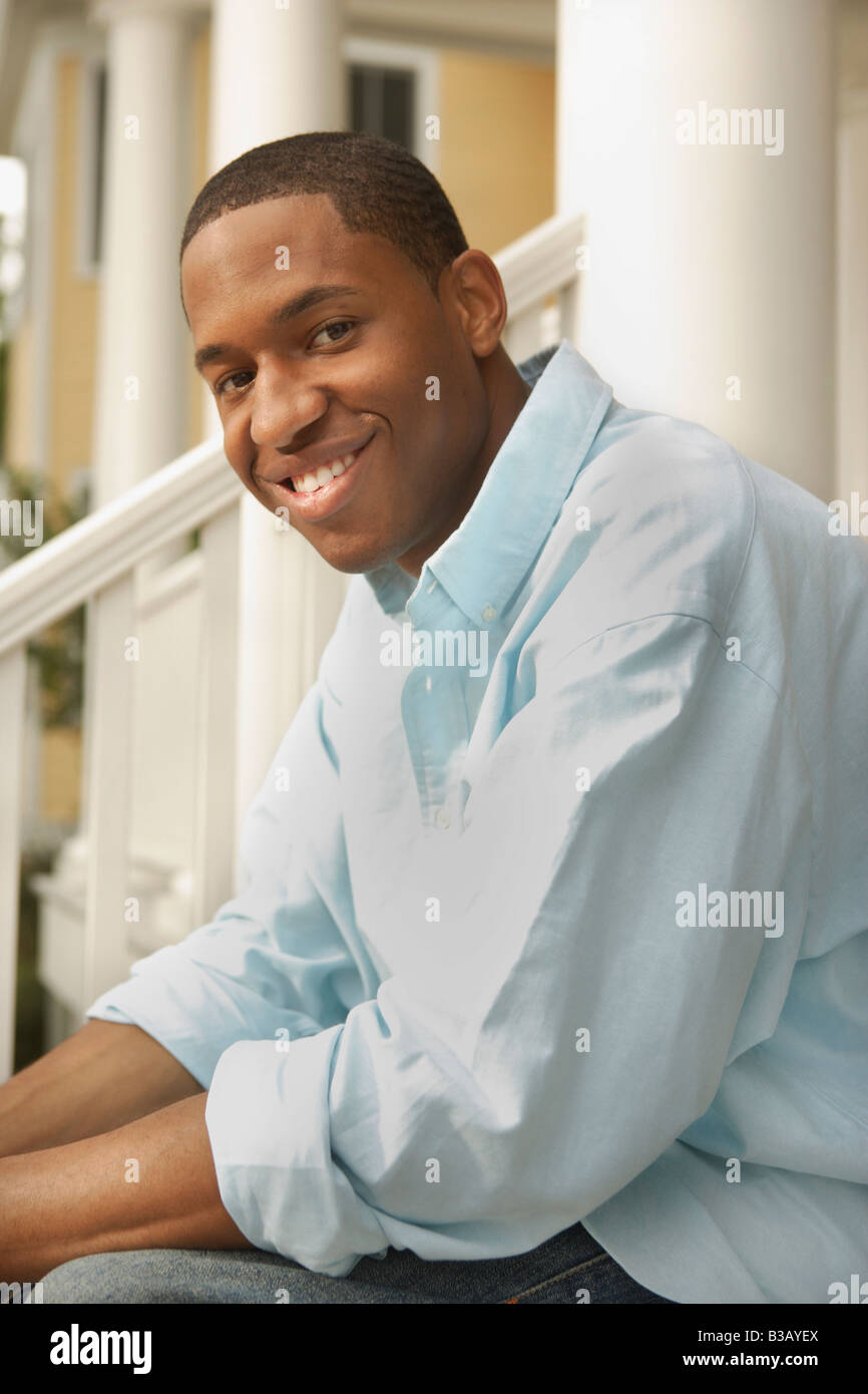 African man sitting on porch steps Stock Photo - Alamy